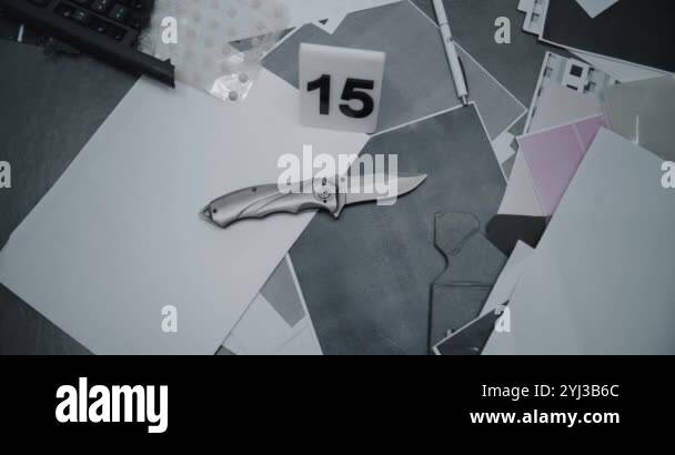 Bank robbery or murder case. Top view on murder weapon knife lying next ...