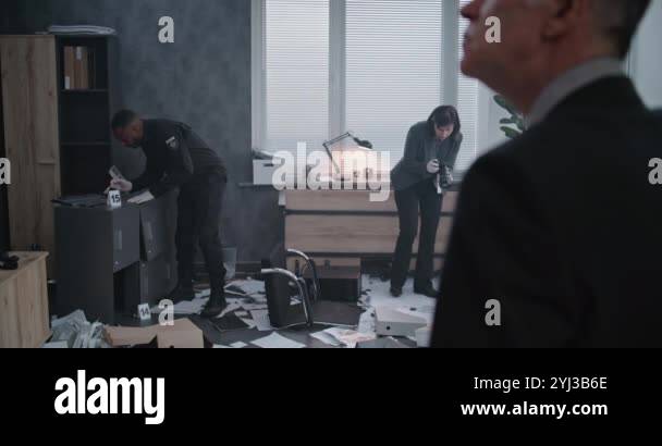 Office robbery case: Crime investigation team working. Male detective ...