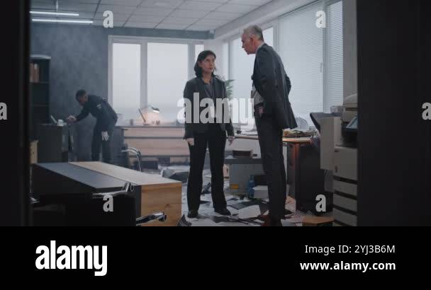 Office robbery case: Crime investigation team working. Male detective ...