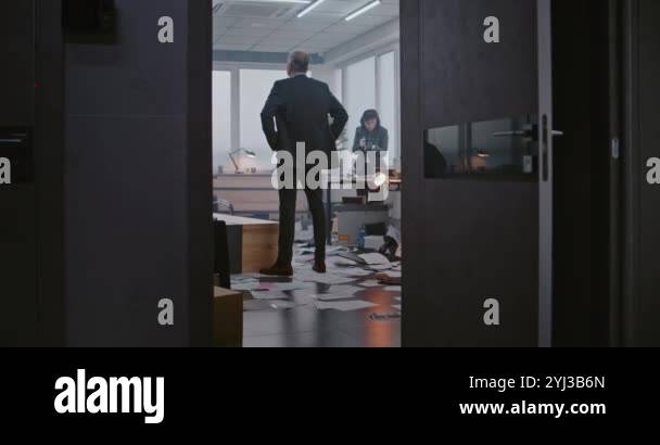 Robbery case in office room: Male detective in suit examines crime ...