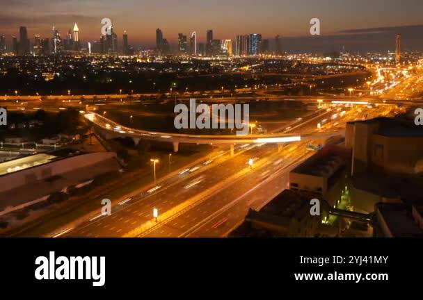 City lights and busy expressway contrast with urban skyline in this ...