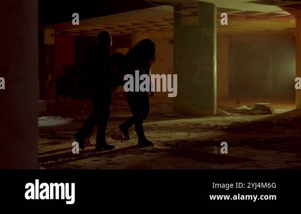 A dimly lit scene in an abandoned building, featuring two shadowy ...