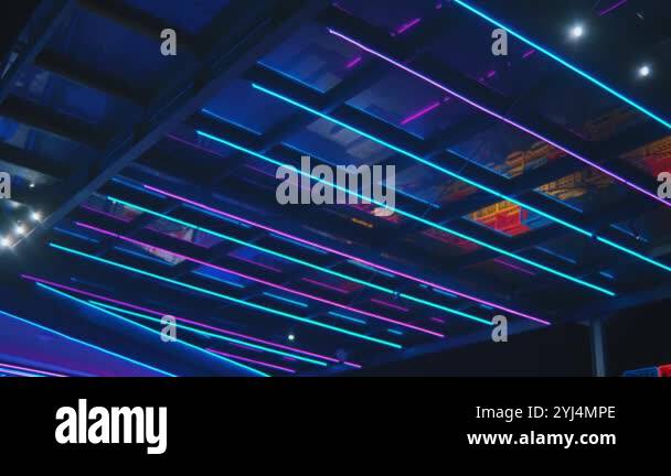 A modern ceiling design featuring vibrant blue and purple LED lights ...