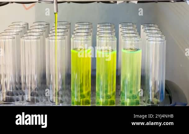 Green fluorescent compound is separated in automated machine. test tube ...