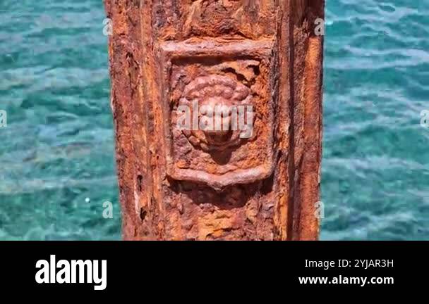 ornamental rusty lighthouse lamp pole at a sea pier, Kokkala, Mani ...