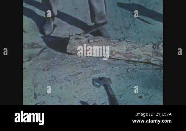 US - 1956 - in this western, men are making a new wooden axle with ...