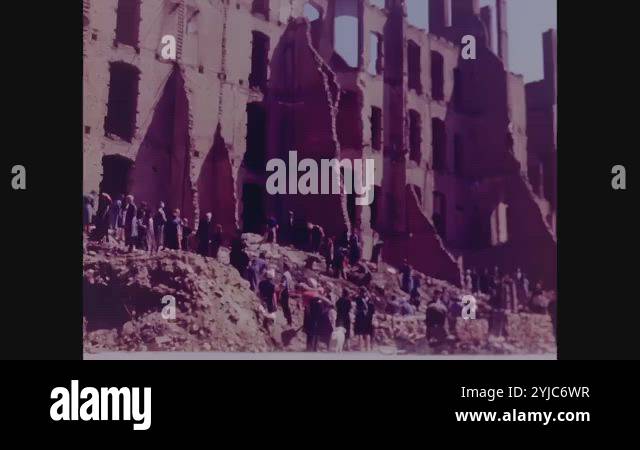 BERLIN - 1945 - Pan of civilians cleaning up rubble in war-torn Berlin ...