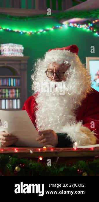 Vertical Video Santa Claus checks his list twice in this warm Christmas ...