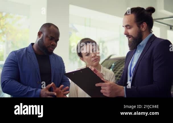Portrait of cheerful salesman talking with customers, showcasing ...