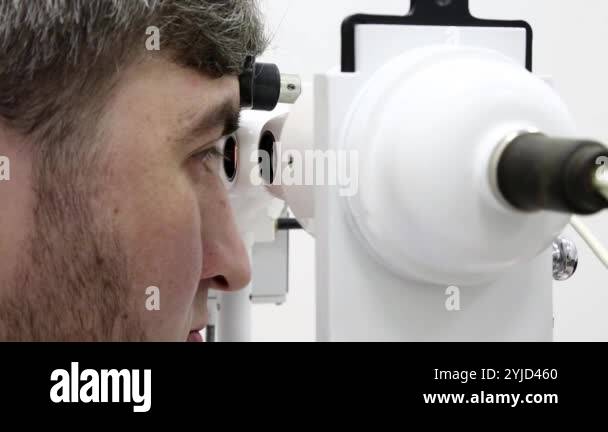 Patient in ophthalmology clinic. Man looks in synoptophore - ophthalmic ...