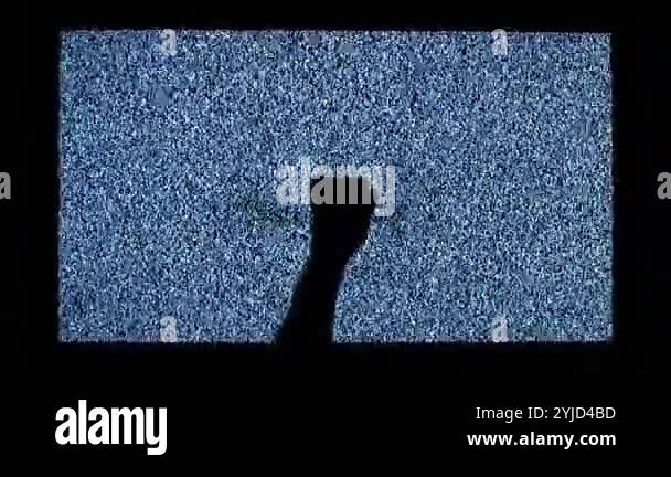 TV channel noise and black silhouette of hands in television screen ...