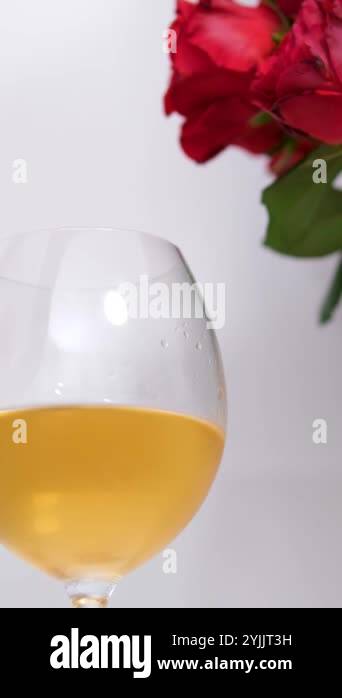 Ice cube falls to a glass of juice fruit. Ice cubes throw at ...