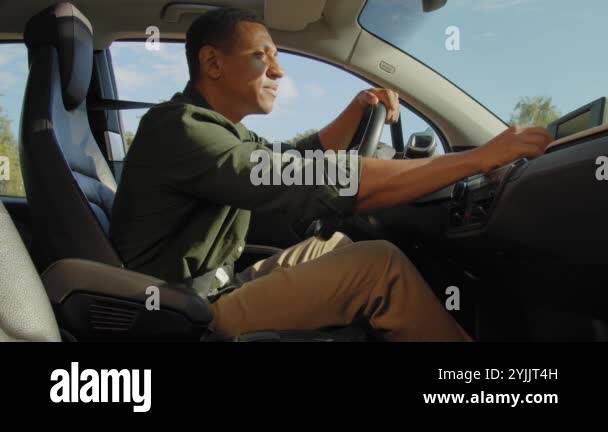 Attractive black man driver in smart casual clothes choosing travel ...