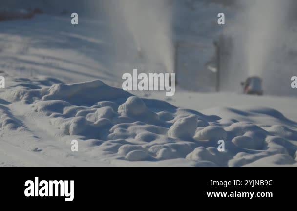 Snow Guns Blow Artificial Snow on the Ski Hill Track. Snowmaking is the ...