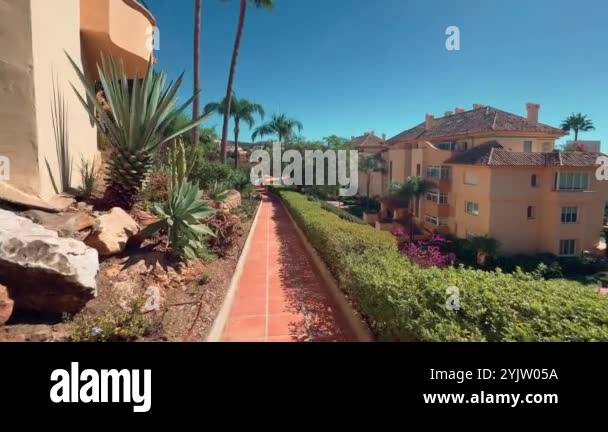 A scenic FPV view of a Mediterranean-style walkway lined with ...