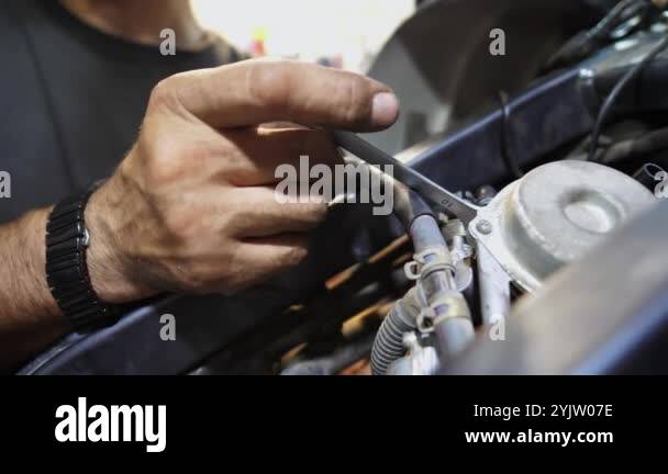 Male hands of repairer fixing motor of motorbike using tool at ...