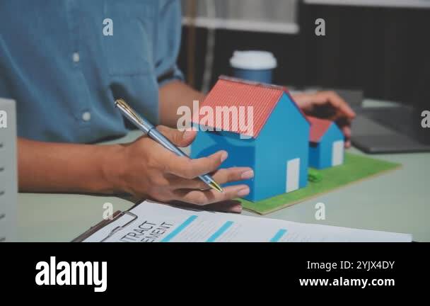 real estate house concept. house model with house plan, man or agent holding house model and ...