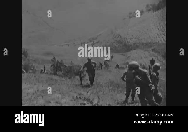 YONGSAN - 1950 - 5th Marines soldiers run up a hill, lay prone, and ...