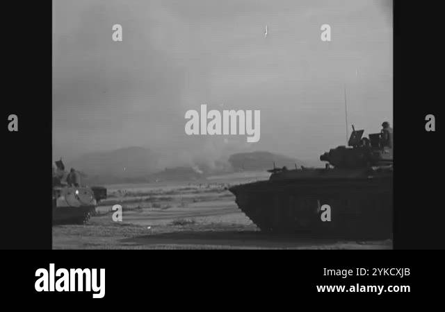 KOREA - 1950 - UN troops wait on beach, look toward the distance, and ...