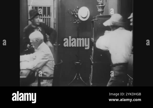 US - 1914, in this silent comedy, some men carry an overweight baseball ...