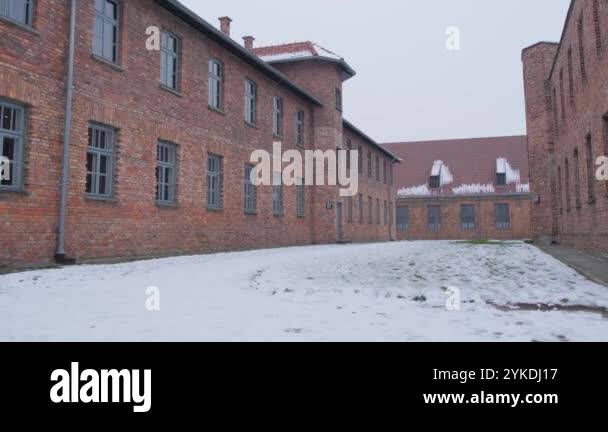 In front of a brick building covered in snow lies the snowcovered ...