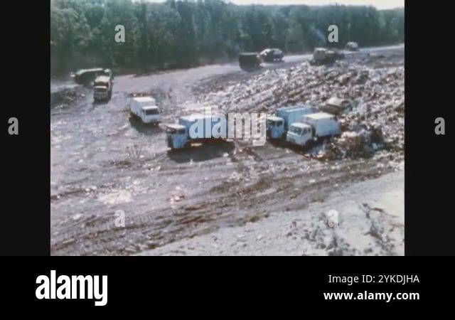 USA - 1970 - Garbage is compacted and covered with soil at a sanitary ...