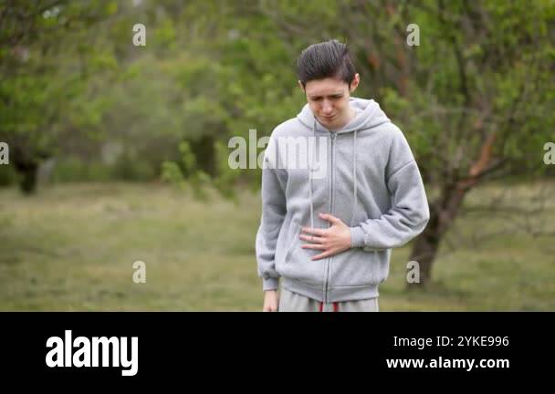 Teenage boy writhing in stomach pain, dealing with intestinal issues ...