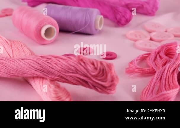 Close-up view of cotton fabric, buttons and spools of threads, floss ...