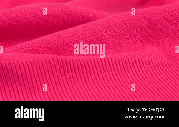 Close-up view of pink color cotton jersey fuschia shade. The textile ...