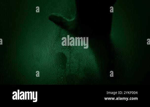 Horror scene of a hands against wet shower glass. Two hands pressing ...