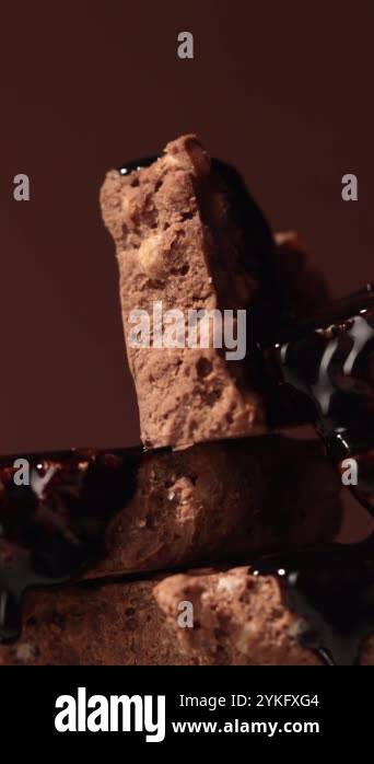 A close-up video of a gourmet chocolate bar slowly getting drenched in ...