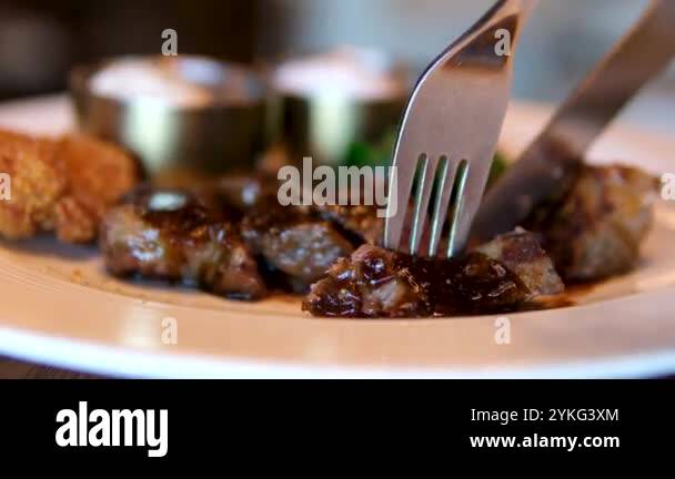 Close-up of thick roast beef being sliced, showcasing the tender, juicy ...
