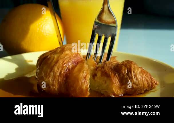 Cutting croissant with knife. Close up view. puff pastry bakery product ...