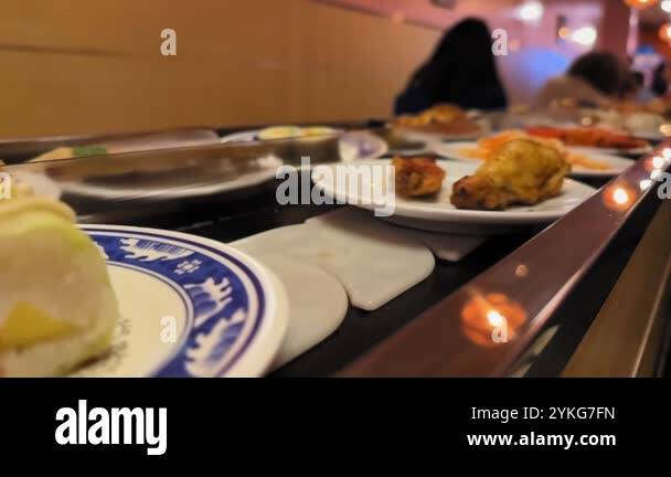 A lively atmosphere fills the air as diners sample diverse dishes from ...