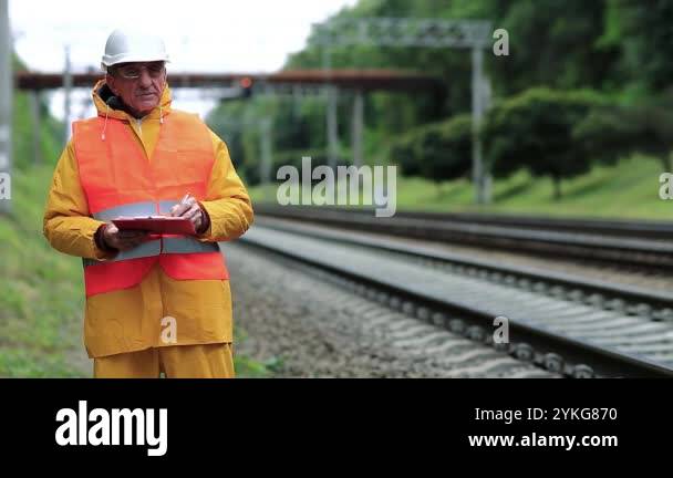 Inspector of railway traffic makes notes in his documents. Railway ...