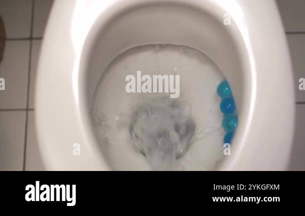 stream of water drains into toilet, foaming with detergent. cleaning ...