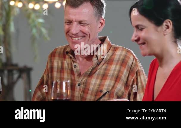 Old couple celebrate holiday in garden. Retirement age senior having dinner. Outdoor camping ...