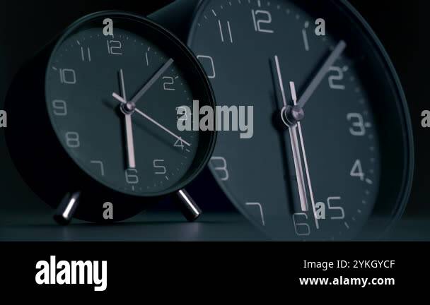 Two sleek and stylish black analog clocks, beautifully showcasing a ...
