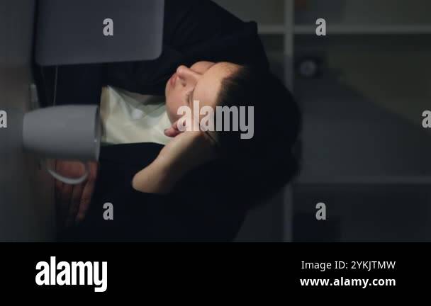 Vertical video. Work fatigue. Night shift. Exhausted workaholic ...