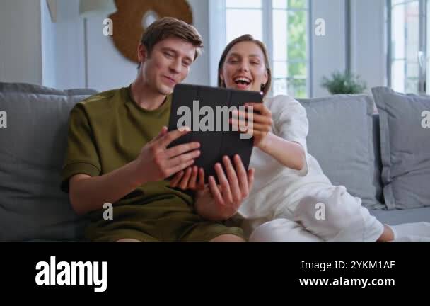 Boyfriend girlfriend video calling sitting apartment couch together ...