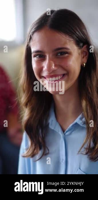Vertical. Primary school girl poses looking smiling at camera sitting ...