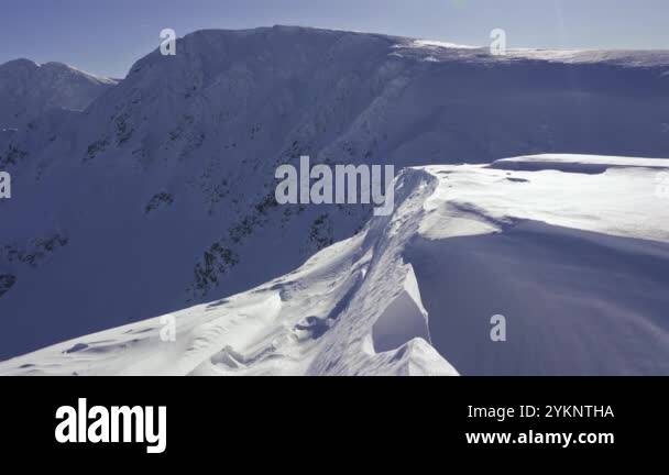 Snowdrift structure of snow in foreground of frozen snowy alps ...