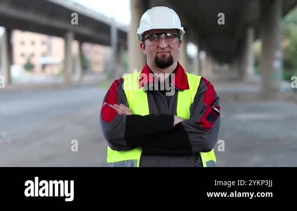 Civil engineer in working clothes, white hard hat and goggles at ...