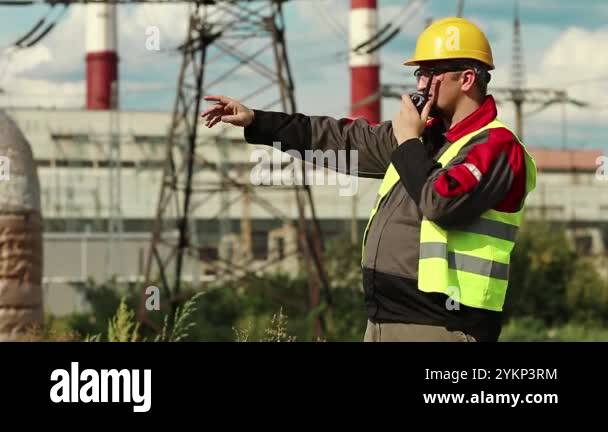 Factory worker with portable radio transmitter on electric power ...