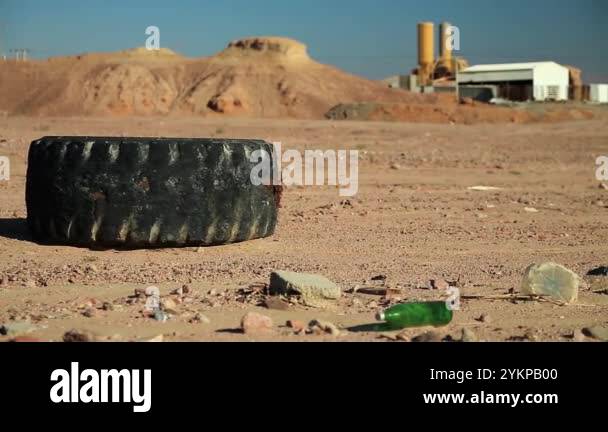 Big old tyre and rubbish lies in desert near Aqaba city in Jordan ...