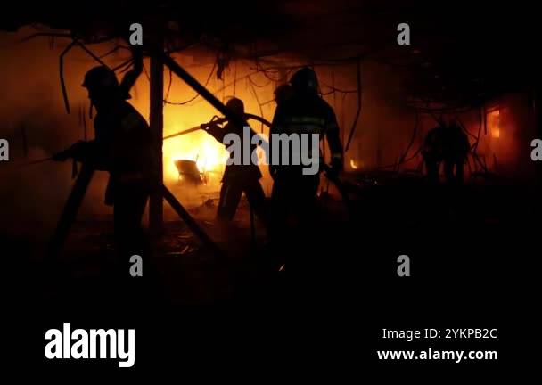 Brave firemen inside burning building. Fire extinguishing, fire brigade ...