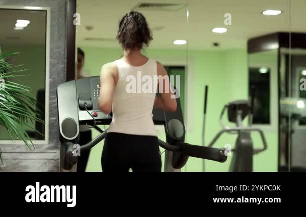 Exercising in gym, treadmill cardio workout. Woman walking on the ...