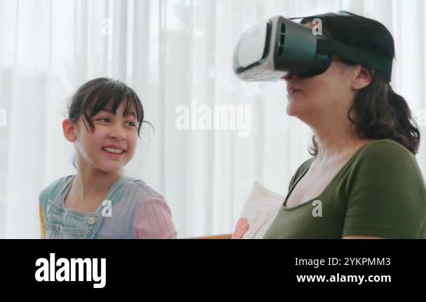 Granddaughter control laptop guide grandmother to dive in metaverse with VR. Senior adapt to ...