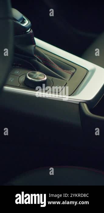Vertical video Close up of car interior gearbox gear shift, transmission control panel and ...