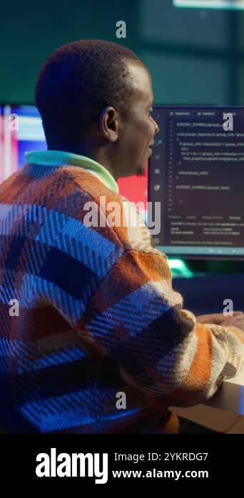 Vertical Video African american IT professional managing AI system for ...